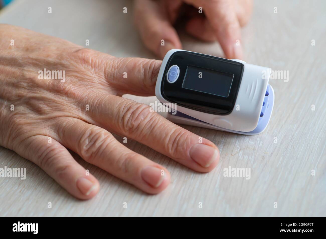 Close-up shot using finger pulse oximeter to check oxygen saturation ...