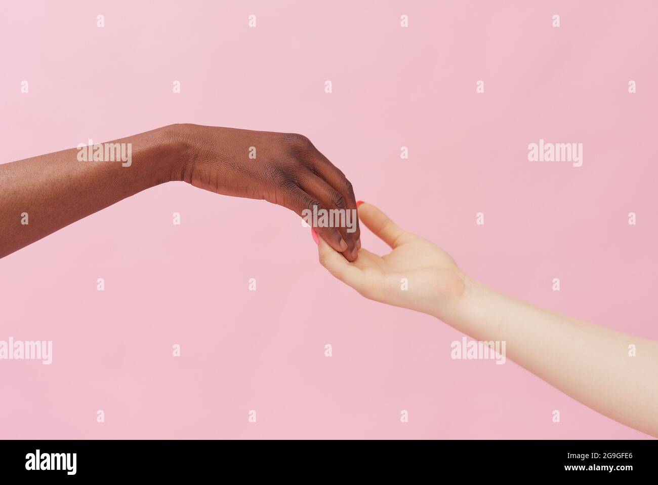 Hands of a Caucasian woman and an African American man touching each ...