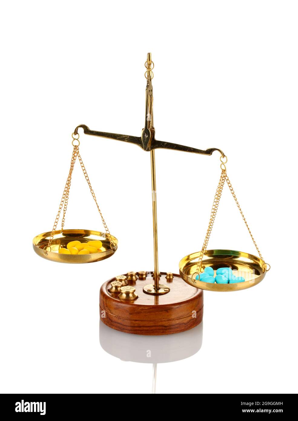 Classic scales with color pills isolated on white Stock Photo - Alamy