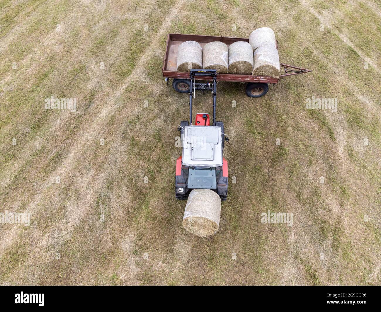 Aerial view of tractor harvesting straw bales Stock Photo - Alamy