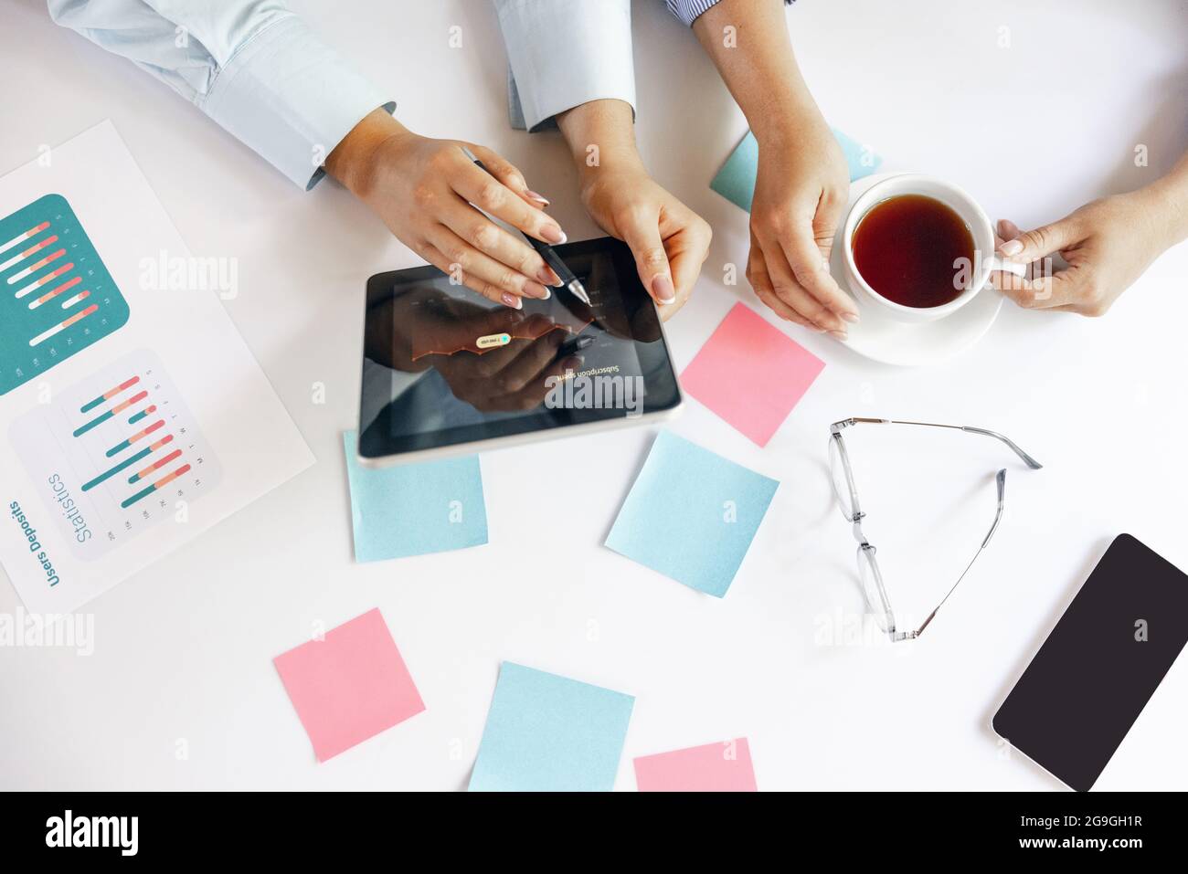 High angle view of female hands during working day, business meeting ...