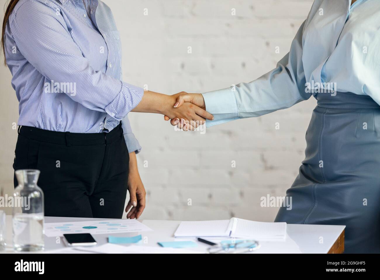 Two young women, colleguas during working day, business meeting ...