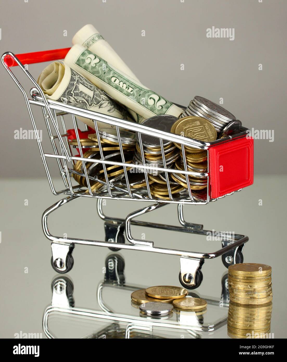 Money in cart on grey background Stock Photo - Alamy