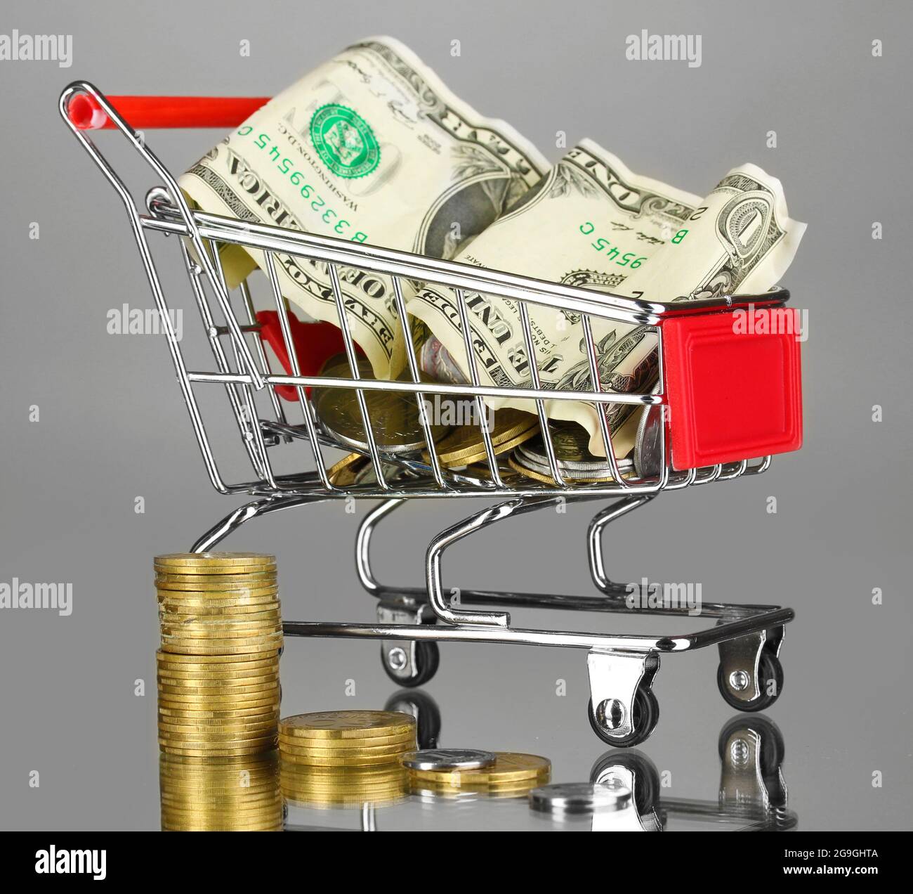 Money in cart on grey background Stock Photo - Alamy