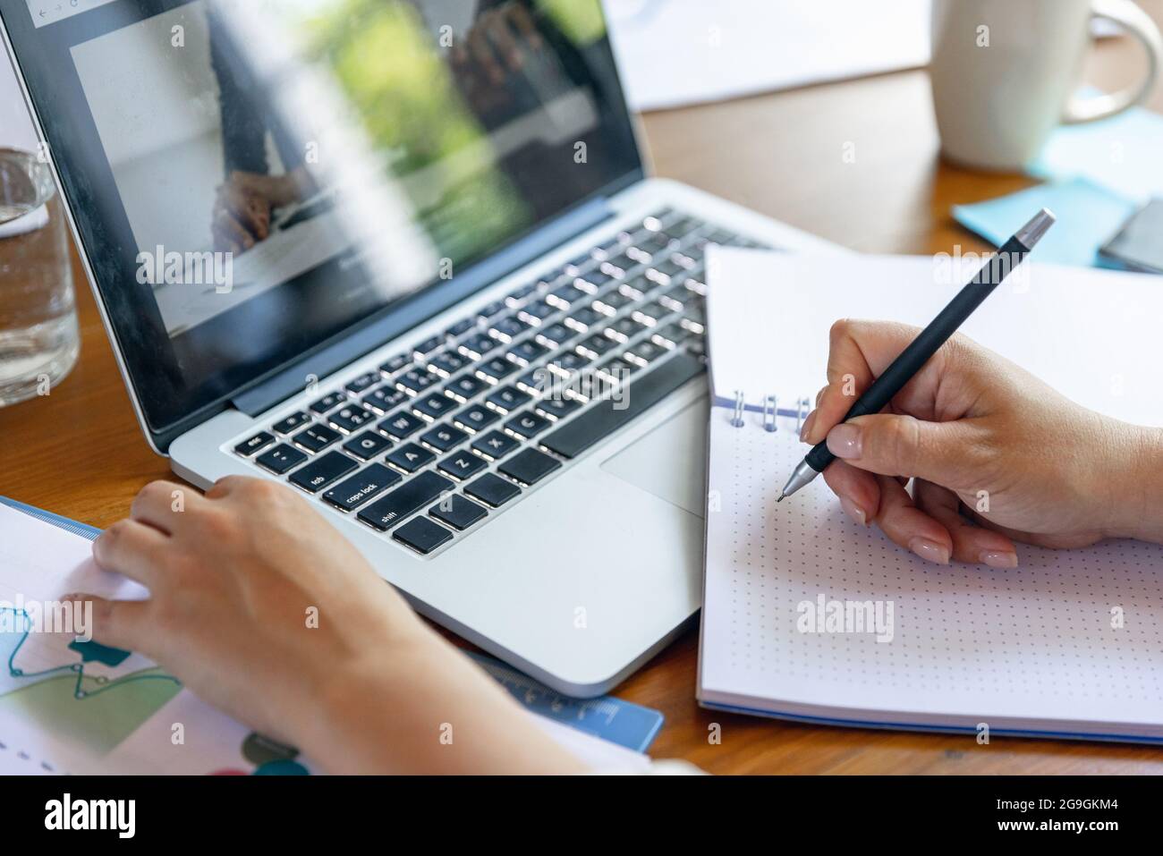 Close up female hands during working office day. Using laptop, modern ...