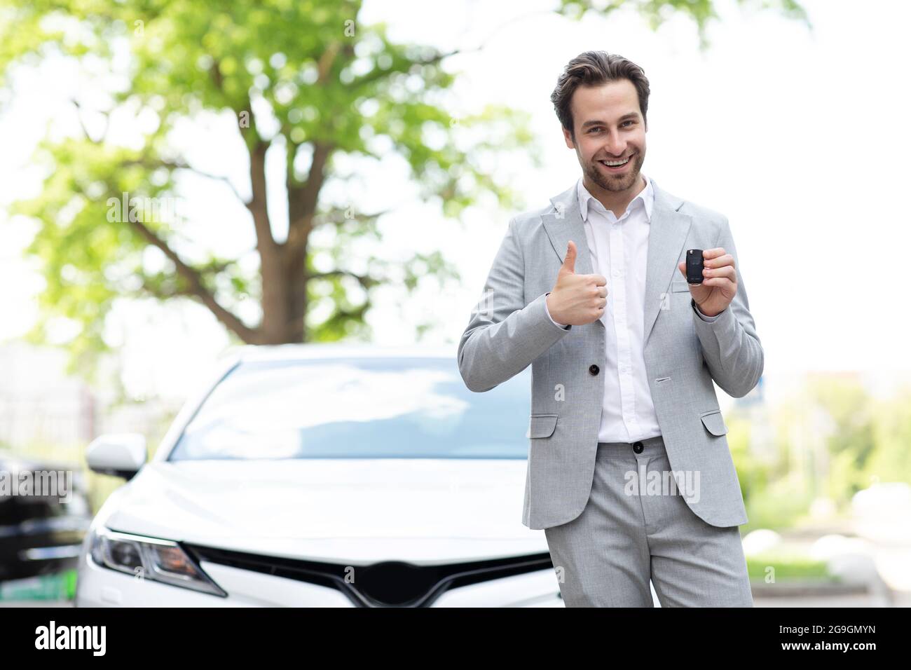 Car service young manager stands hi-res stock photography and images ...