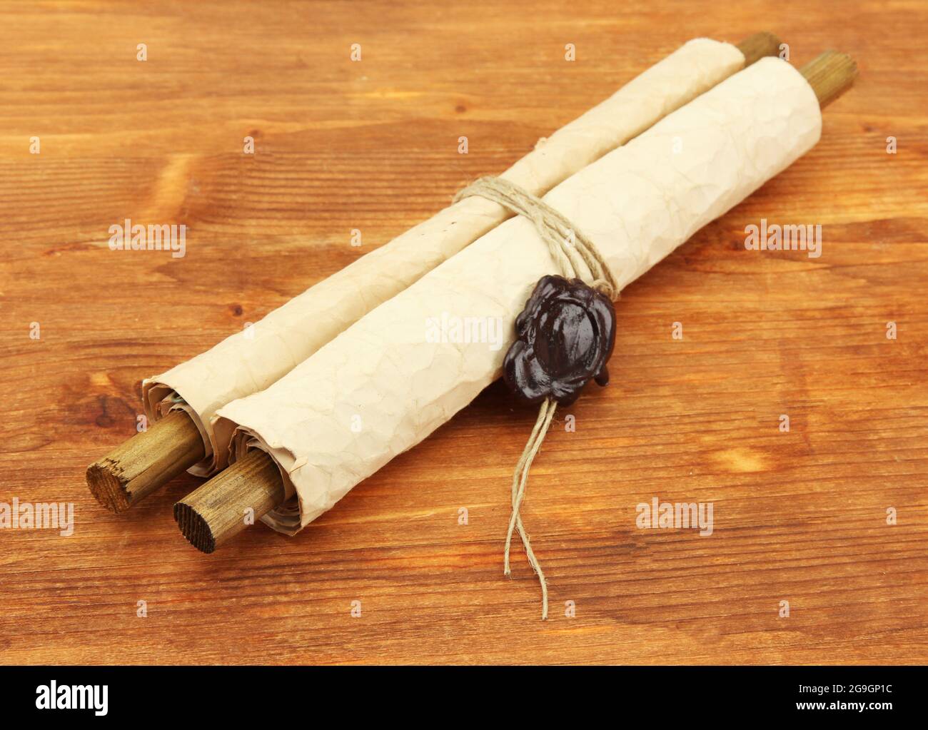 Old scroll, on wooden background Stock Photo - Alamy