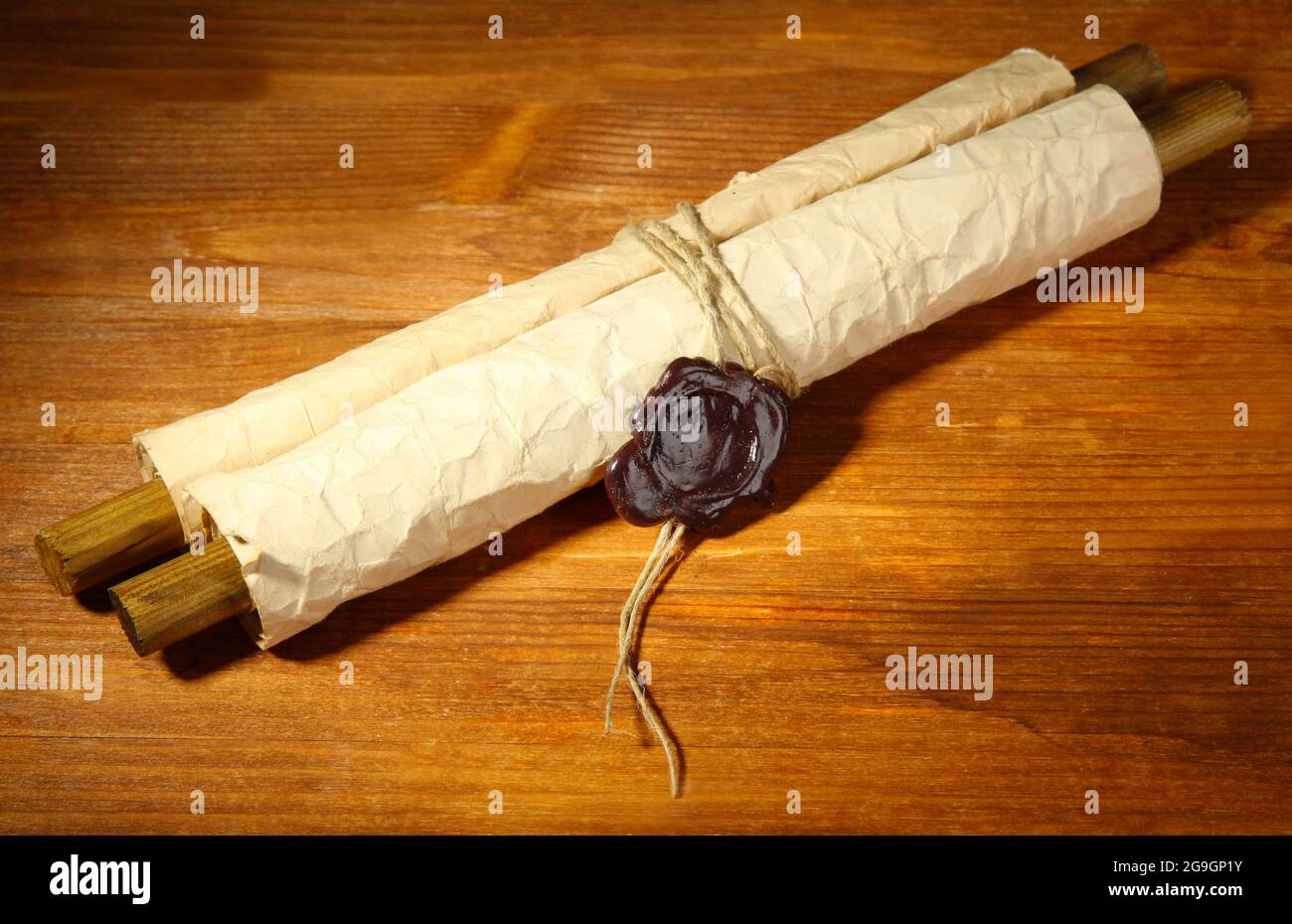 Old scroll, on wooden background Stock Photo - Alamy