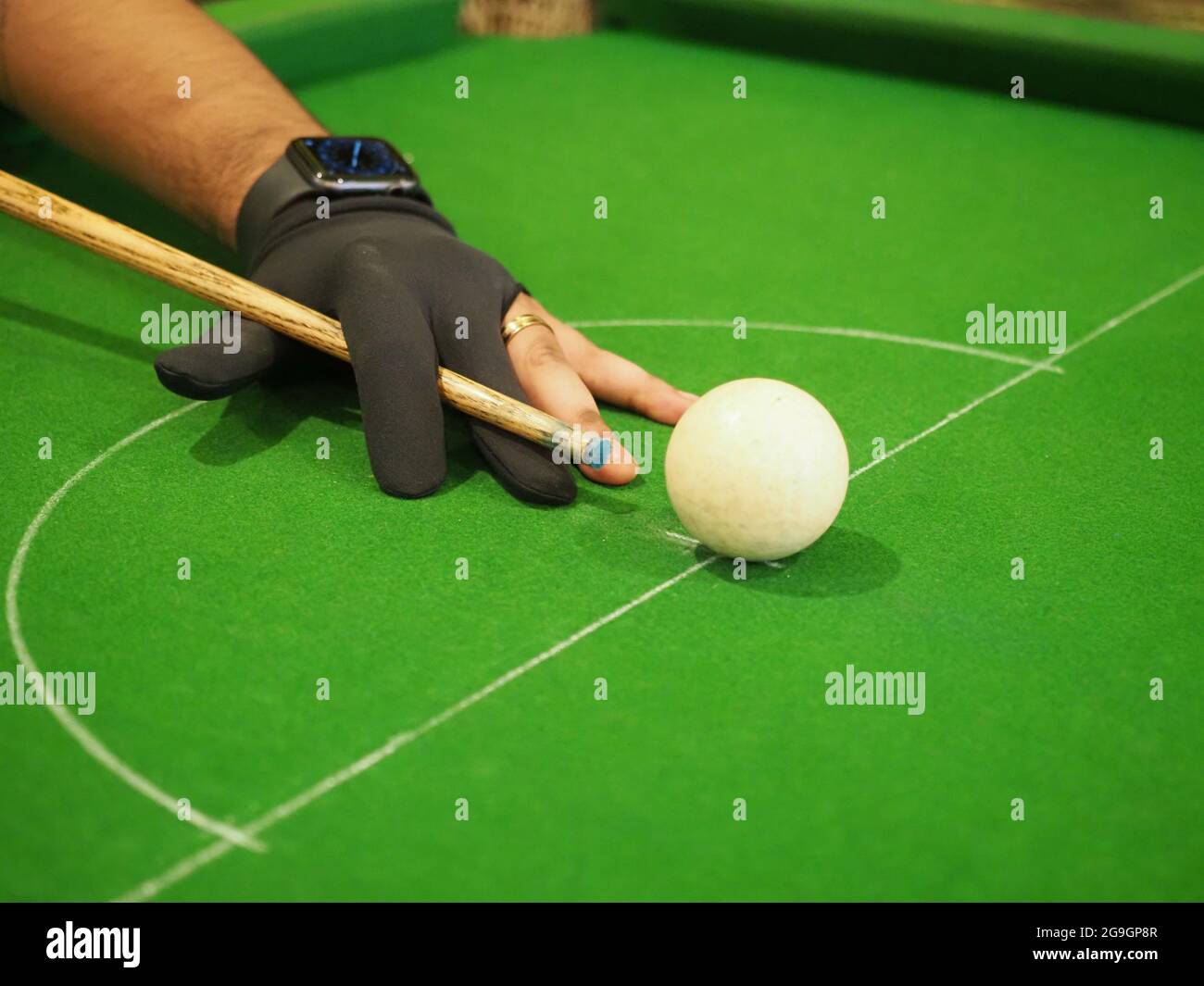KOLKATA, INDIA - Jul 22, 2021: Player aims to a pyramid in billiards ...