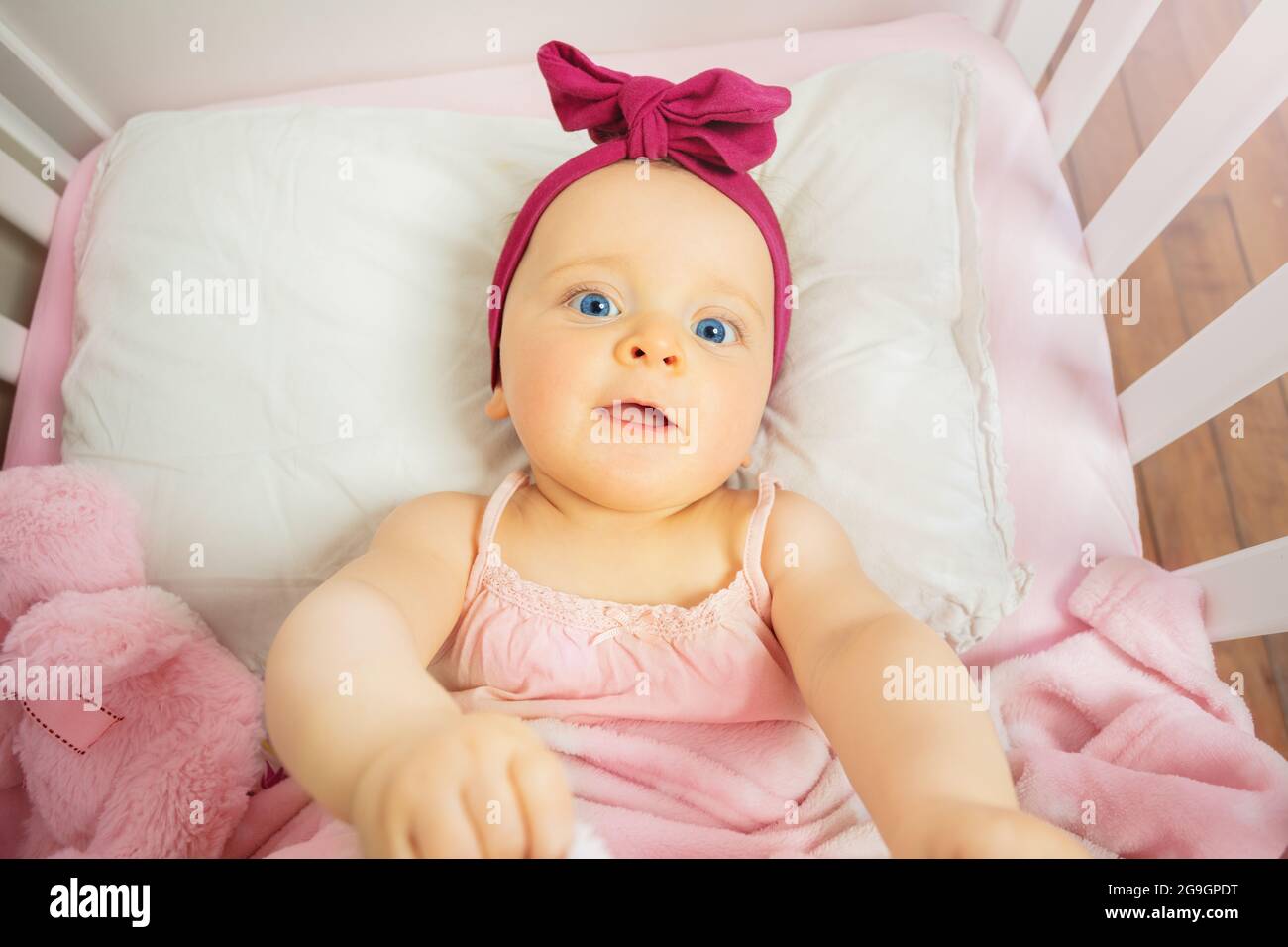View from above of a little baby girl in pink bed Stock Photo - Alamy