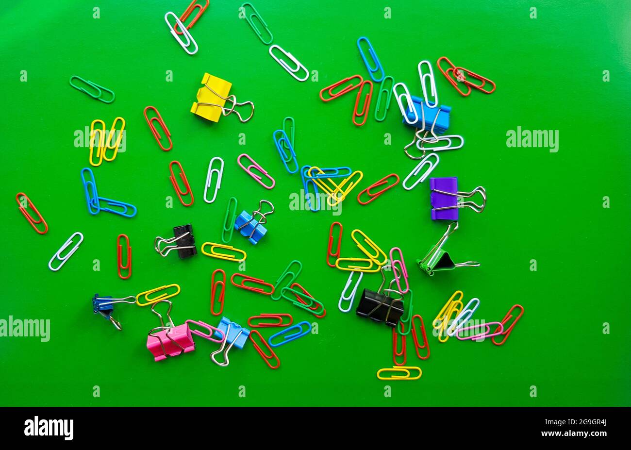 pile of paper clips isolated on green background, documents, office ...
