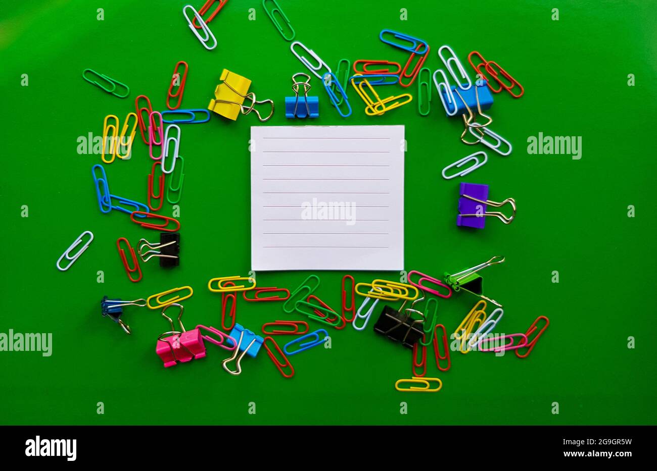 pile of paper clips isolated on green background, documents, office ...