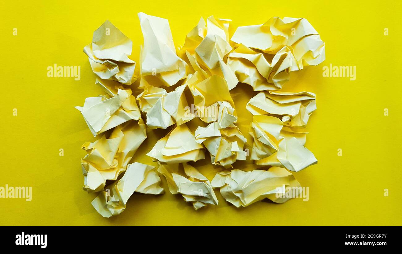 Ball crumpled paper ball isolated on a yellow background. Crumpled ...