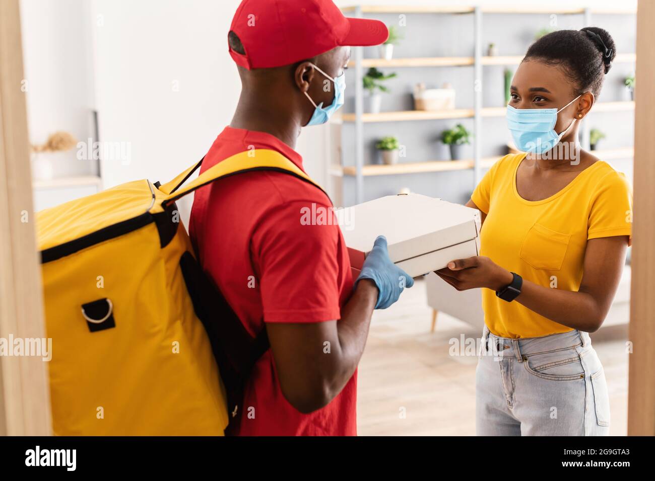 Black Courier Guy Delivering Food To Customer, Giving Happy Lady Pizza ...