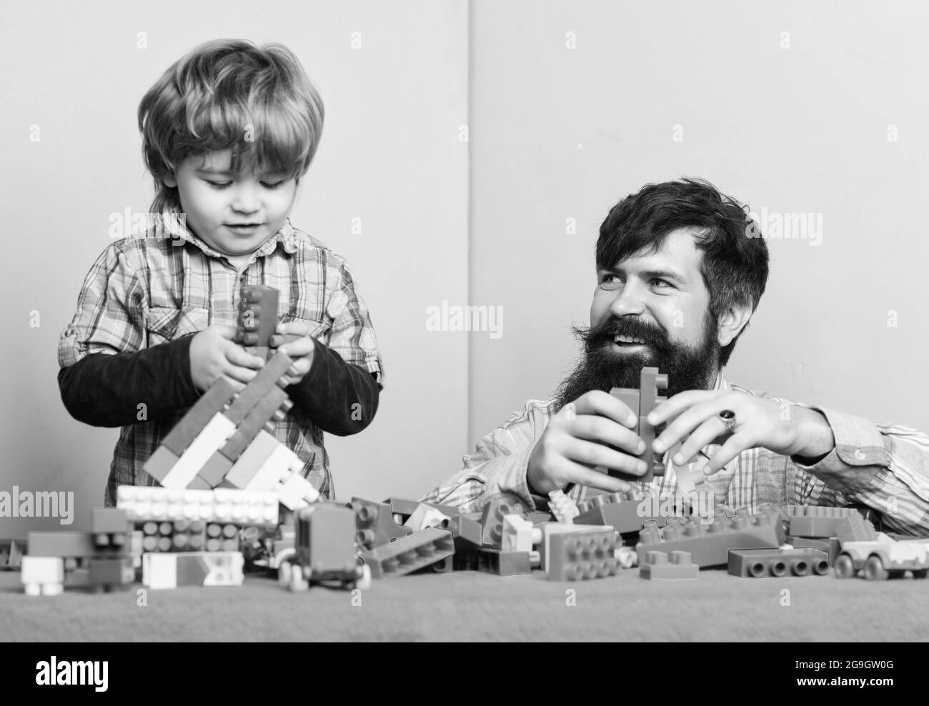 Father son game. Father and son create colorful constructions with ...