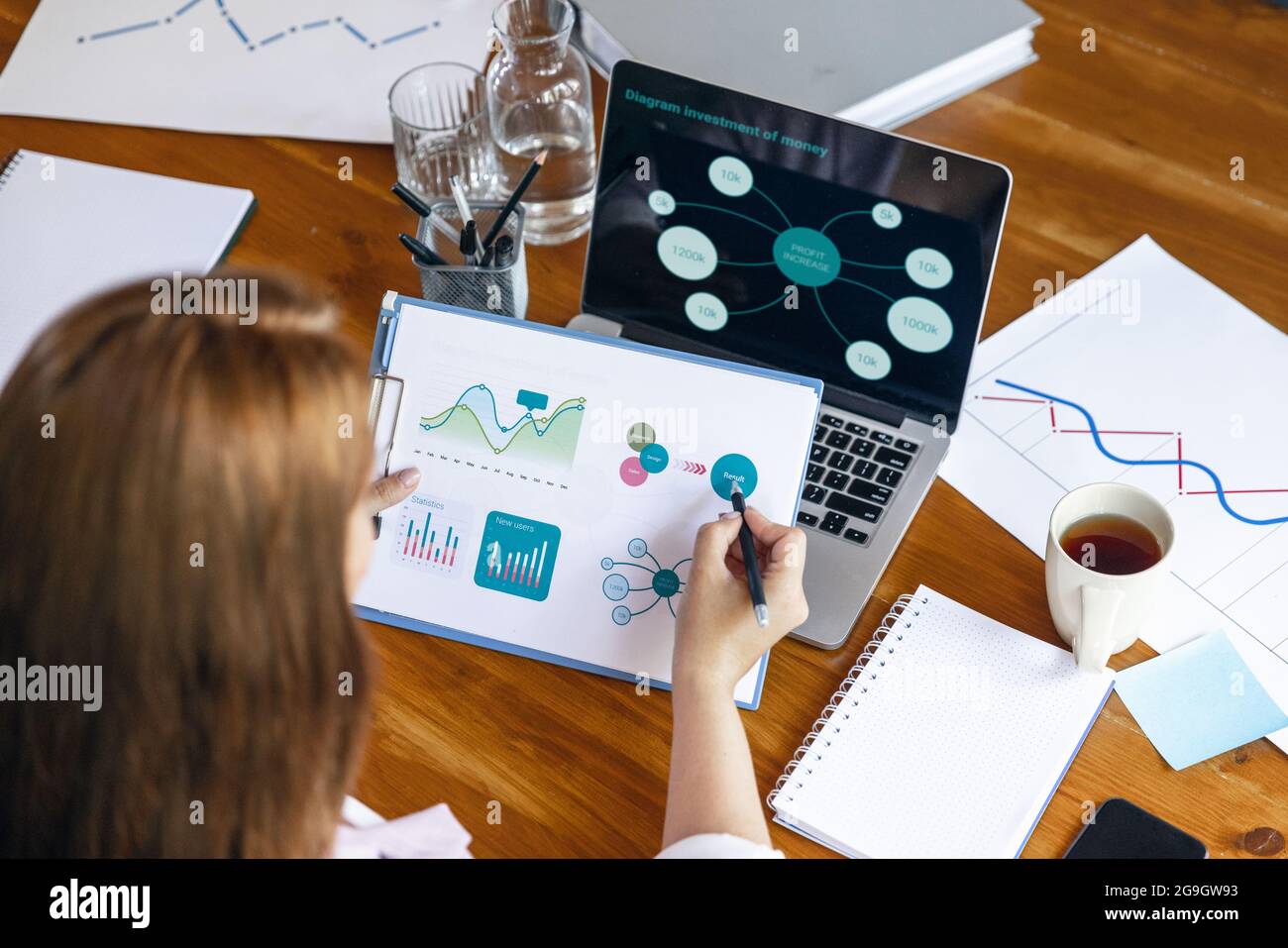Young woman, manager working at office. Using laptop, modern gadgets ...