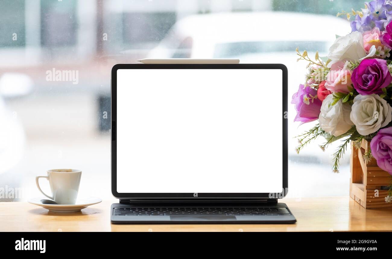 Digital tablet with blank white screen on workplace at cafe Stock Photo ...