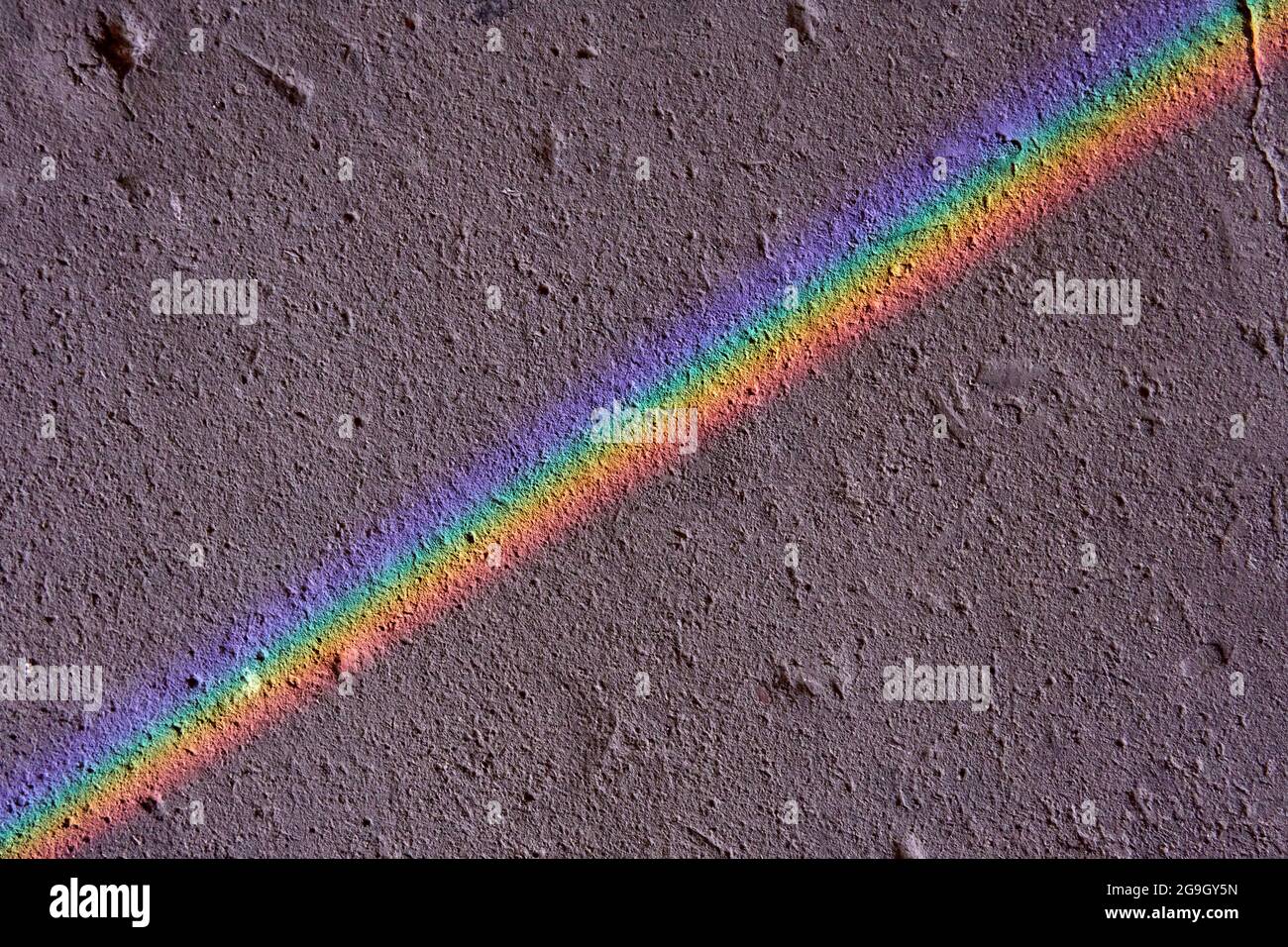 concrete floor with reflection of a line of colored lights, red, orange ...