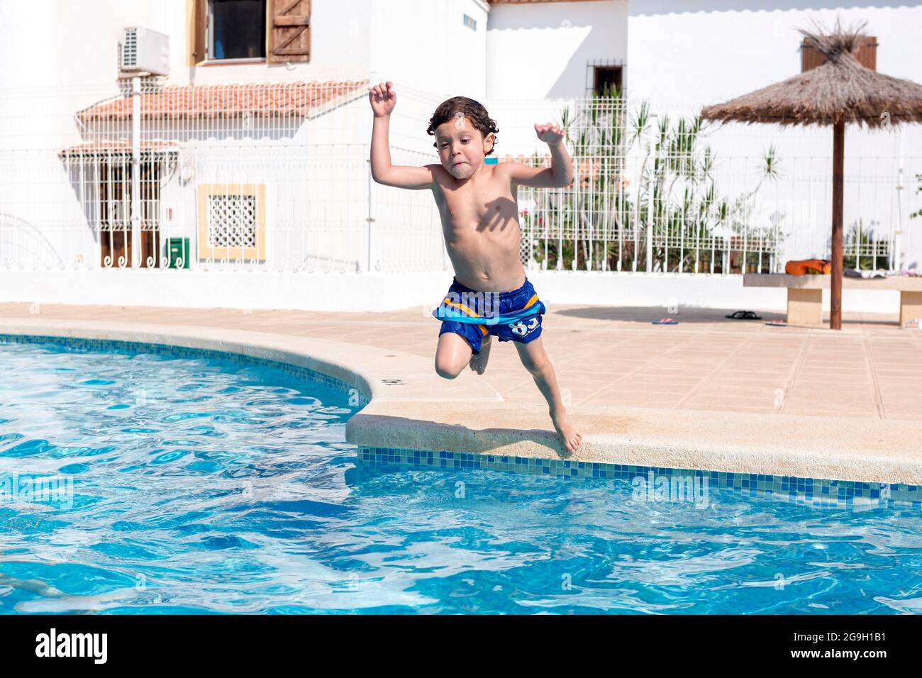 Little kid jumping swimming pool hi-res stock photography and images ...