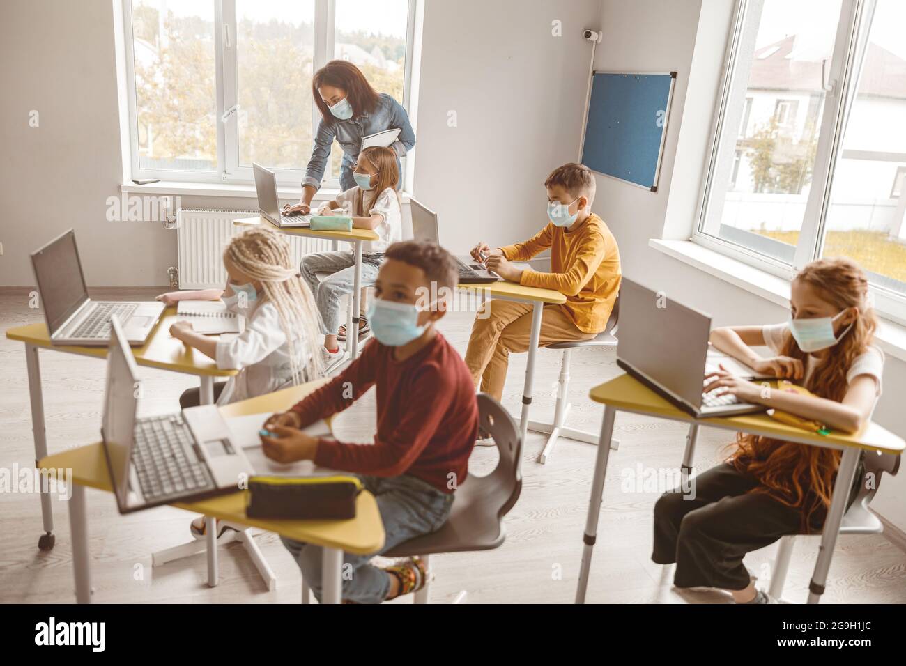 Children wearing masks classroom school hi-res stock photography and ...