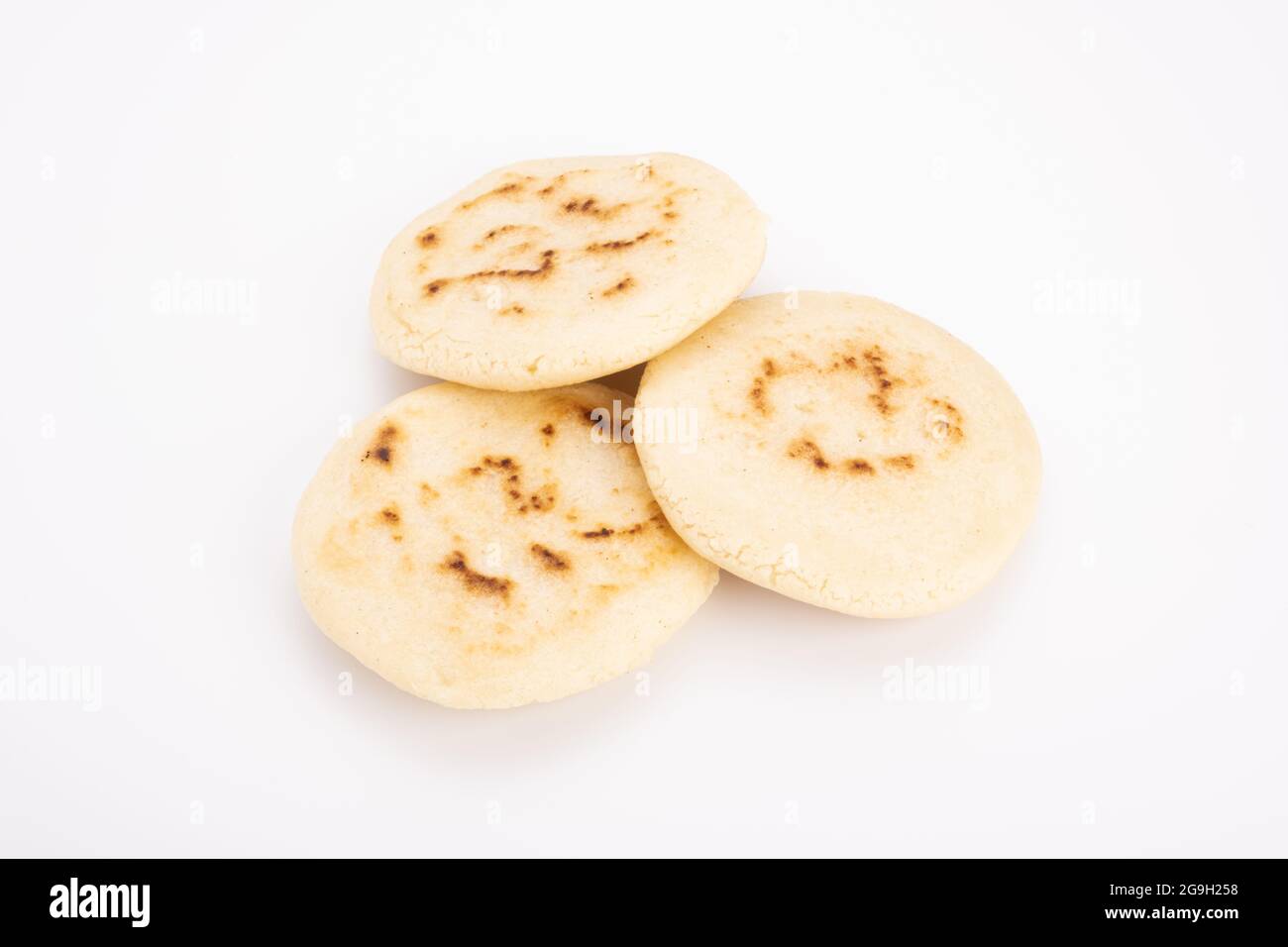 Stack of arepas made with corn flour on a white background, typical ...