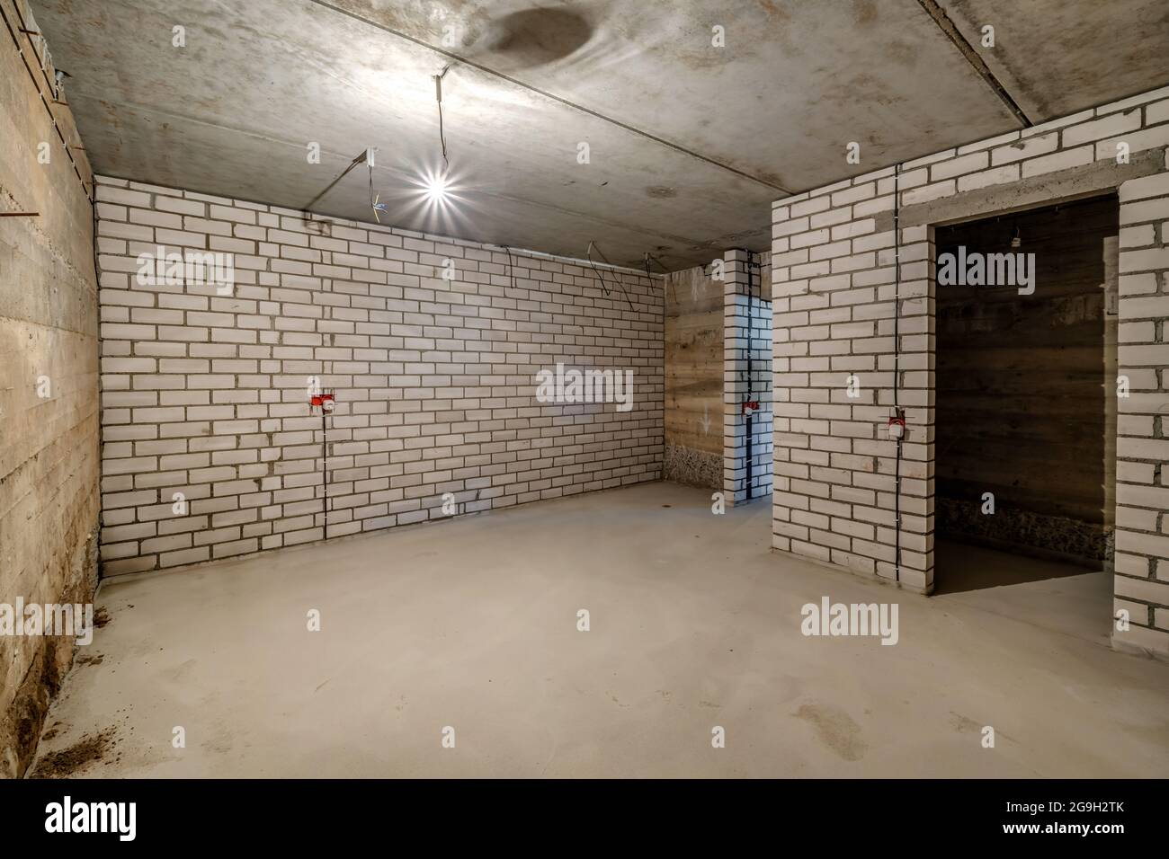 Empty unfurnished basement room with minimal preparatory repairs ...