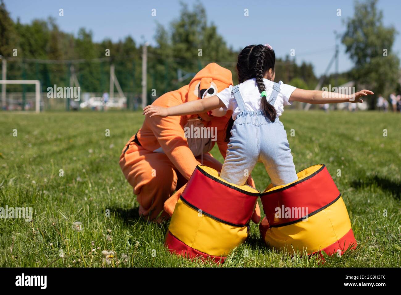 Child in inflatable boots. The kindergartner plays at the party. Boots ...
