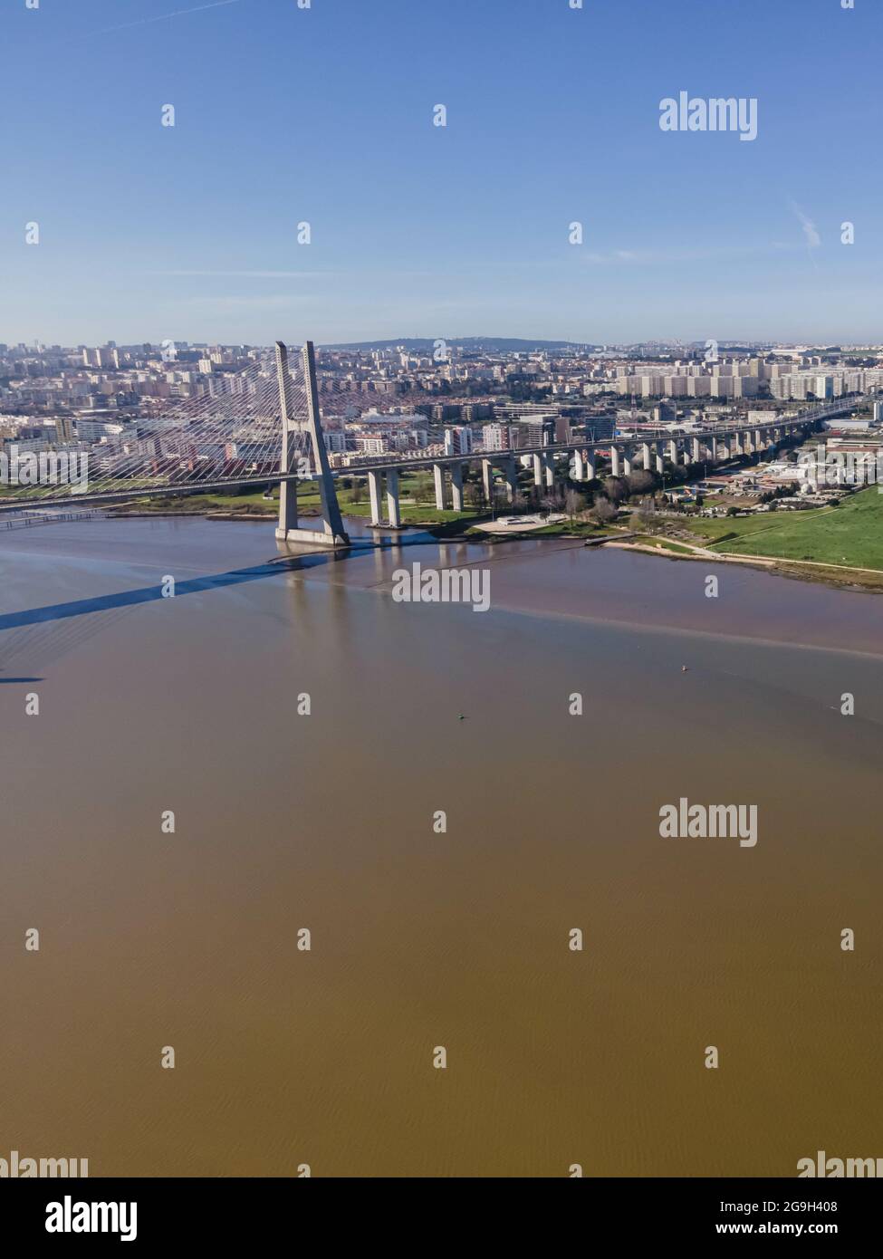 Vertical aerial view of a garden park facing the Tagus river next to ...