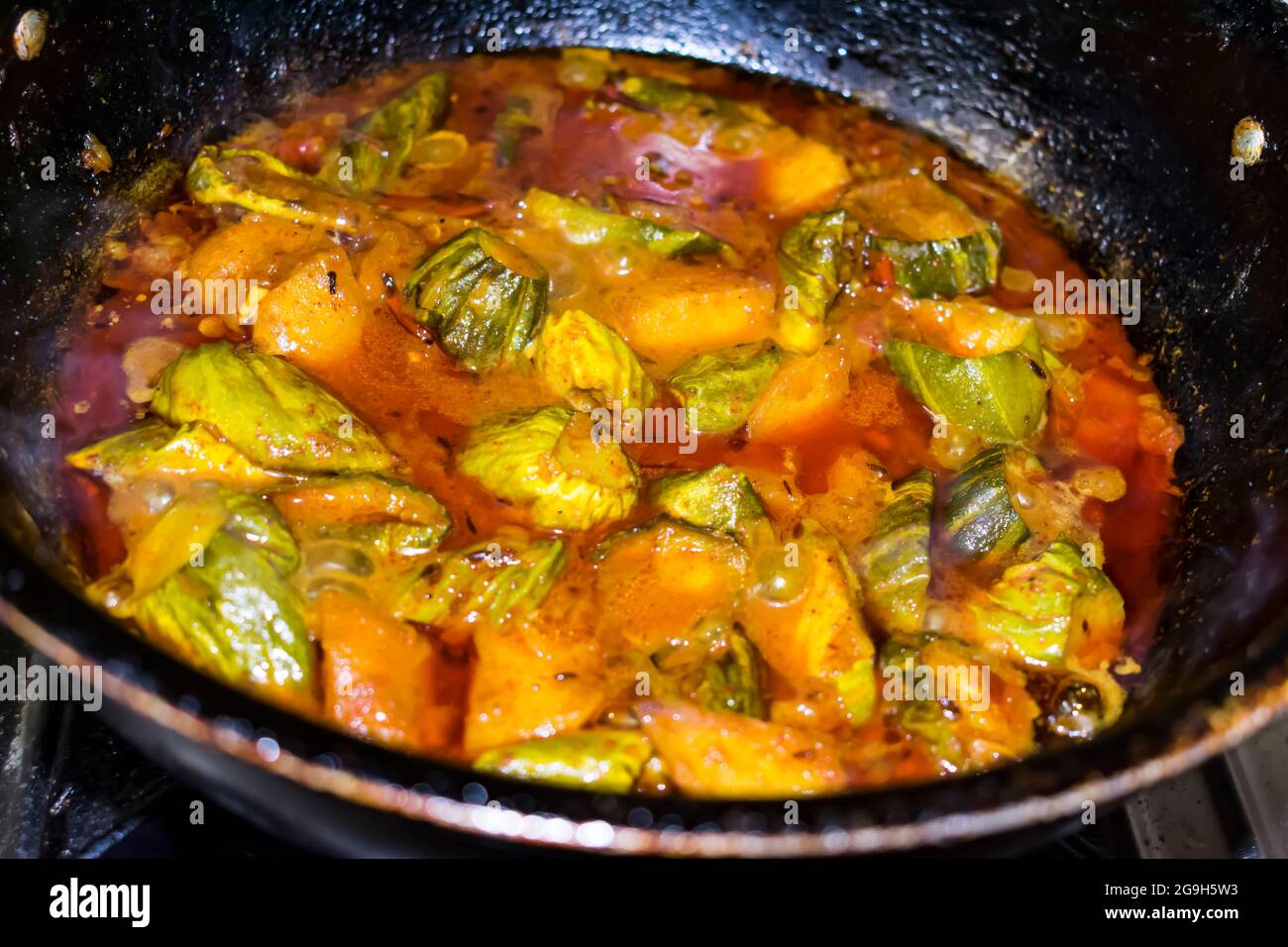 Indian red spicy curry made with potato & Coccinia in home Stock Photo ...