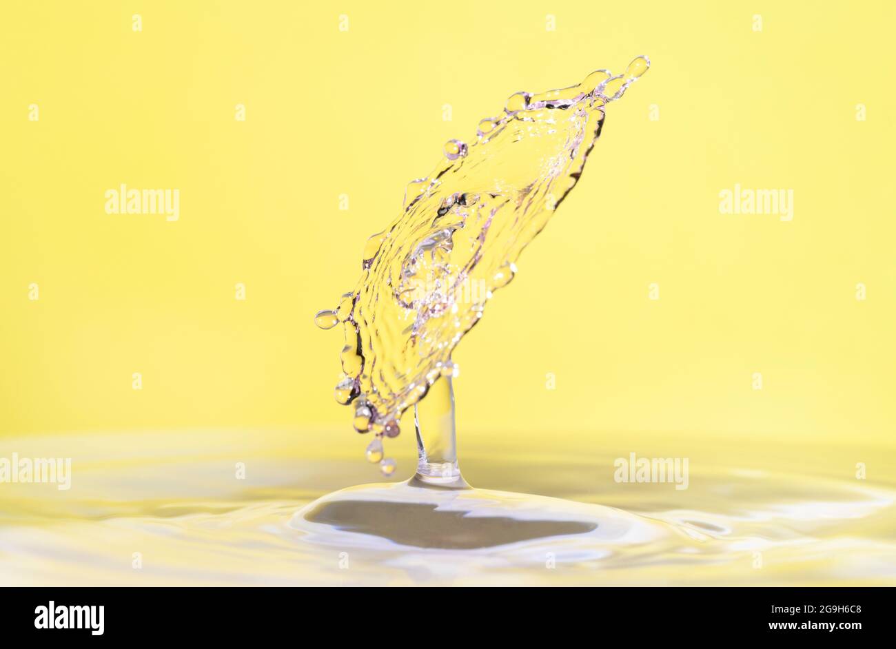 Close-up photograph of two water droplets colliding making an unusual ...