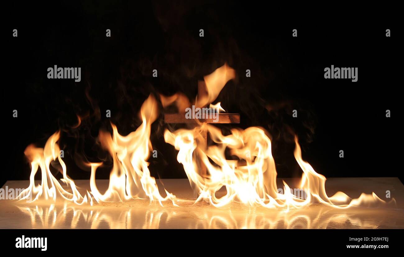 Fire around a burning cross symbol Stock Photo - Alamy
