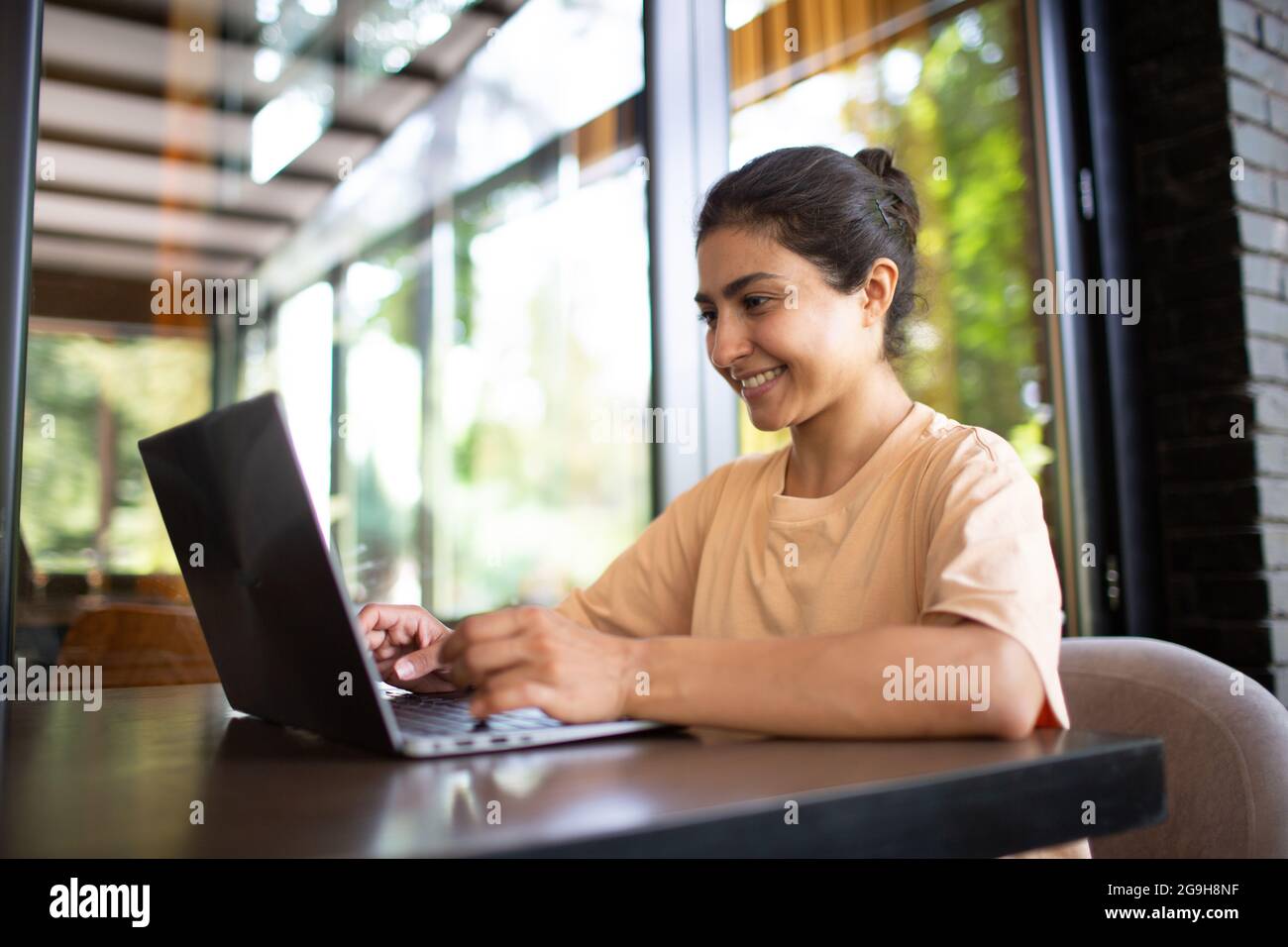 Indian business blogger vlogger woman working on her laptop outdoor ...