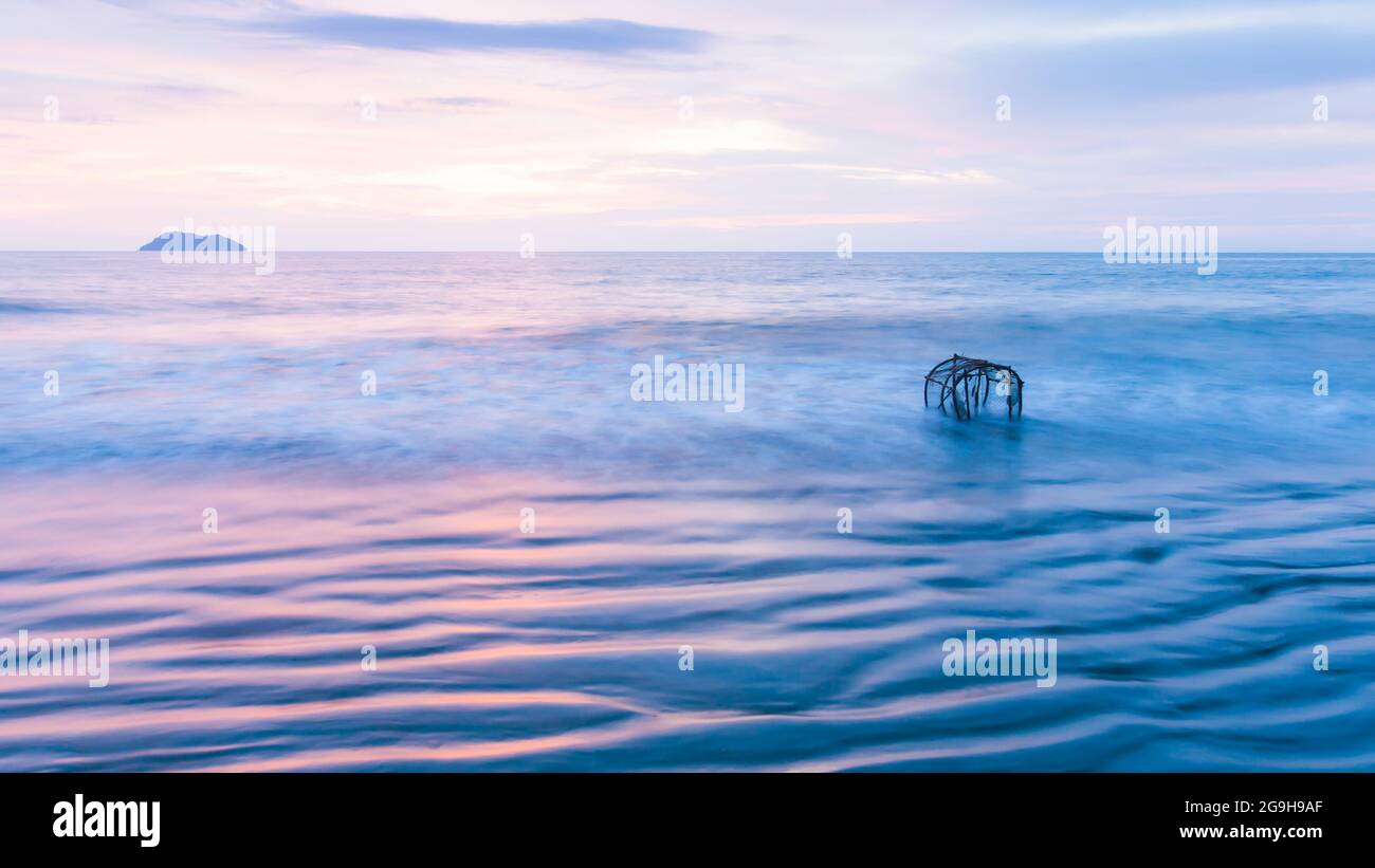 Abstract a tropical beach at sunset. Ocean waves covers wavy sand beach ...