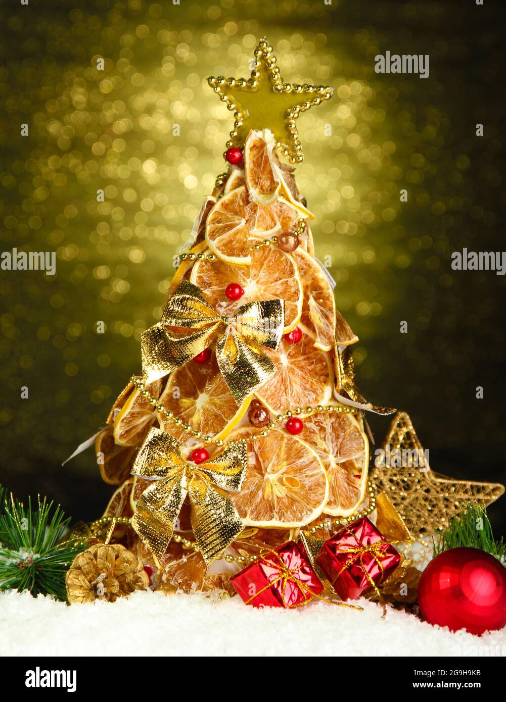 beautiful christmas tree of dry lemons with decor, on shine background ...