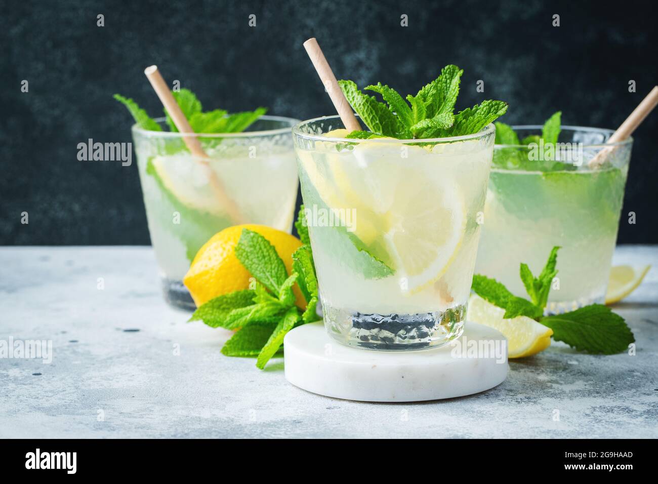 Two glass with lemonade or mojito cocktail with lemon and mint, cold ...