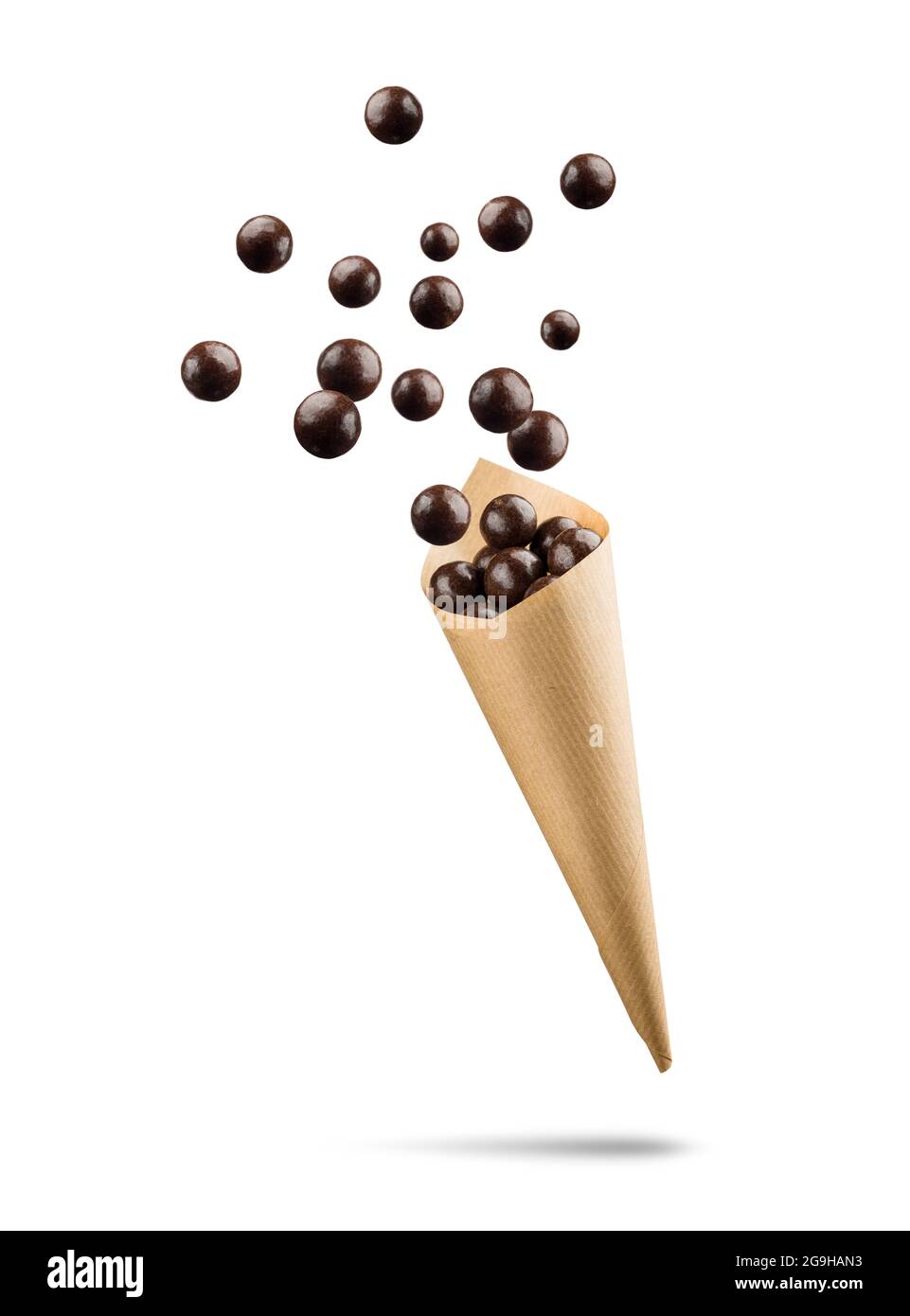 Chocolate pralines in paper cone on white background Stock Photo - Alamy