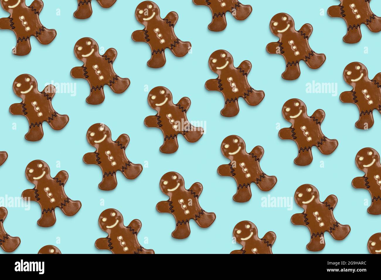 Chocolate gingerbread man pattern on blue background Stock Photo - Alamy