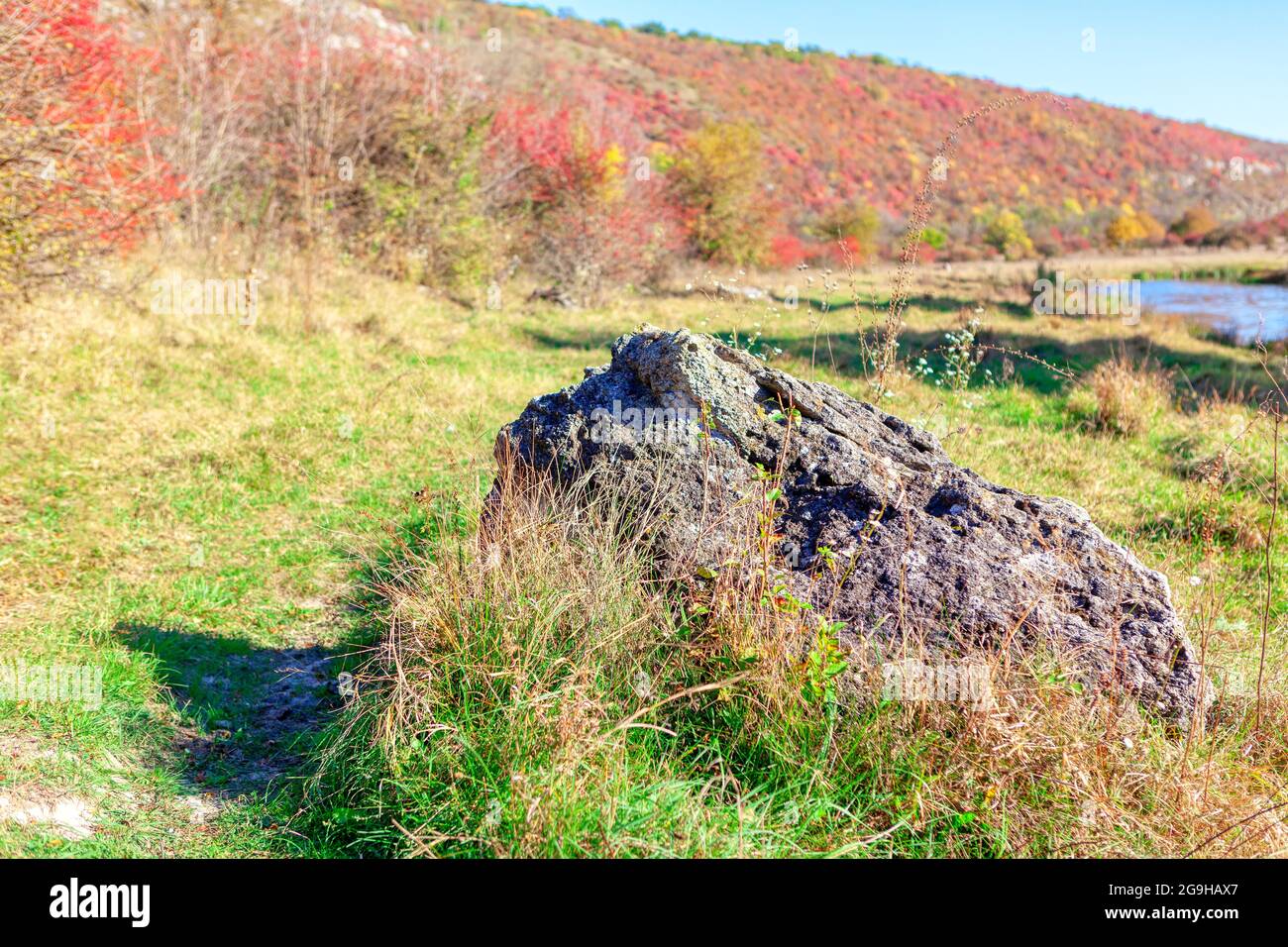 Natural rock in autumn nature . Idyllic scenery of fall season Stock ...