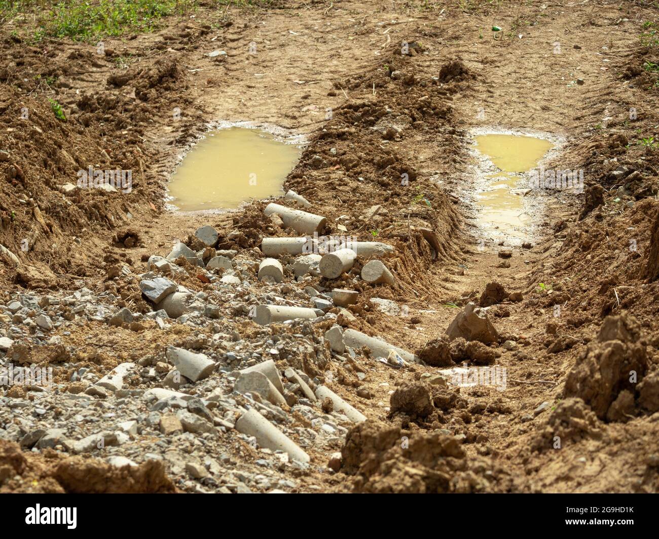 Mud Scraps with Pieces of Cement in the Ground Stock Photo - Alamy