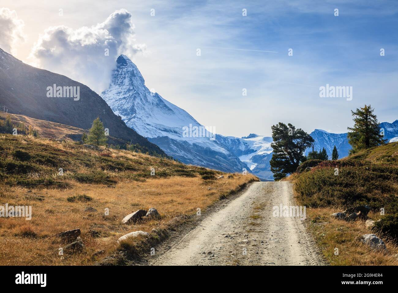 A dirt road in Swiss Alps with Matterhorn in the backdrop Stock Photo ...