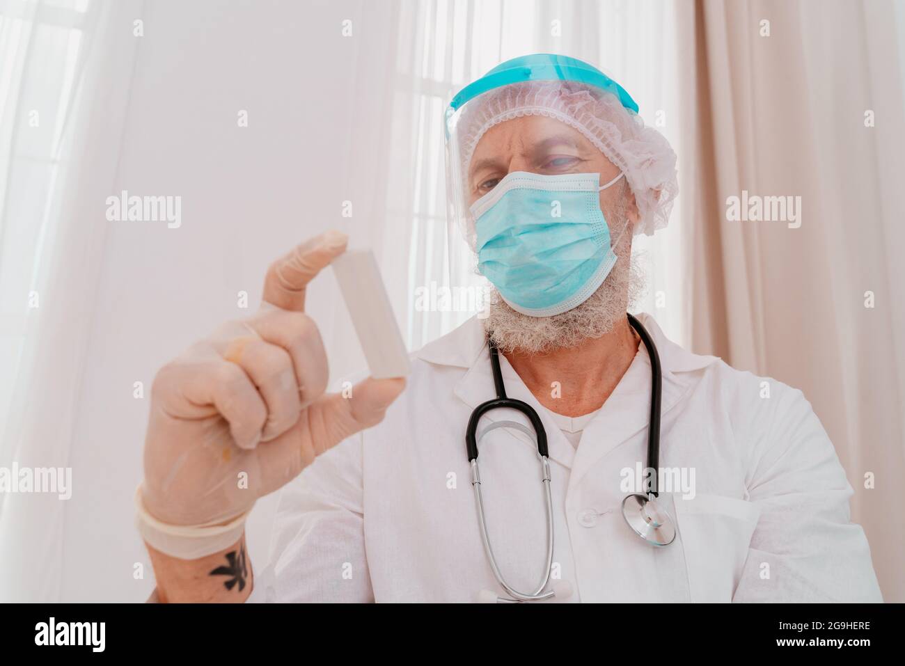 Doctor is checking the covid 19 with a tester Stock Photo - Alamy