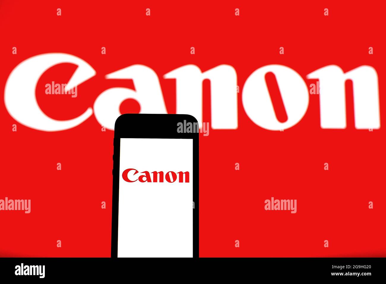In this photo illustration a Canon Inc logo seen displayed on a ...