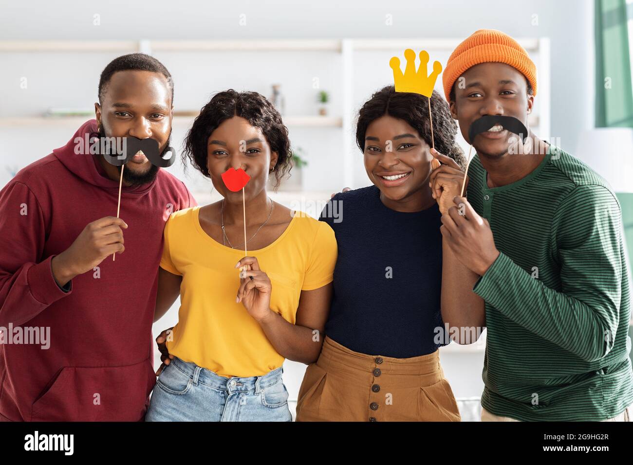 Happy young black friends taking selfie together while having home ...