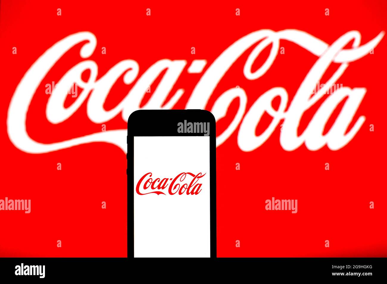 In this photo illustration a Coca-Cola logo seen displayed on a ...