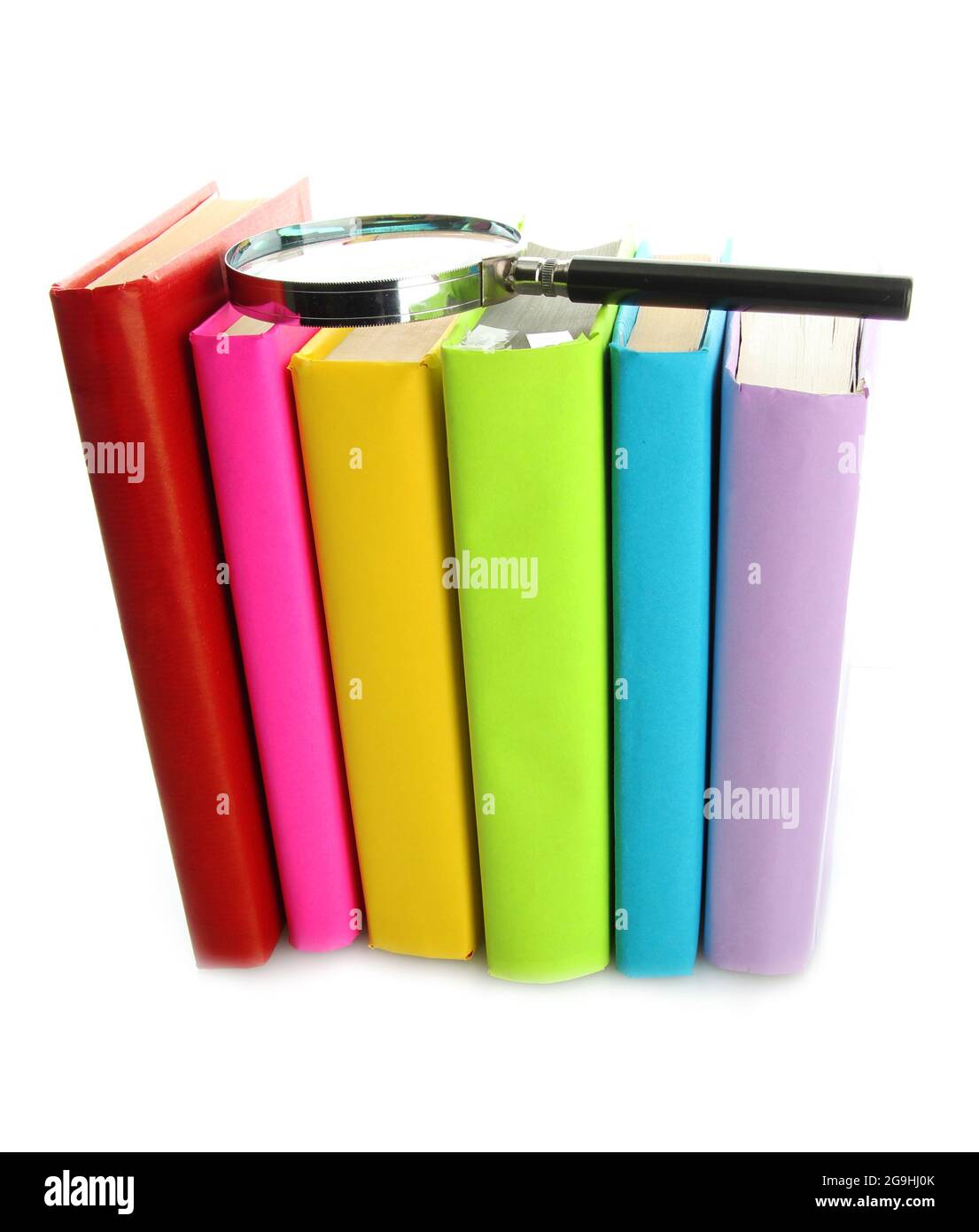 color books with magnifying glass isolated on white Stock Photo - Alamy