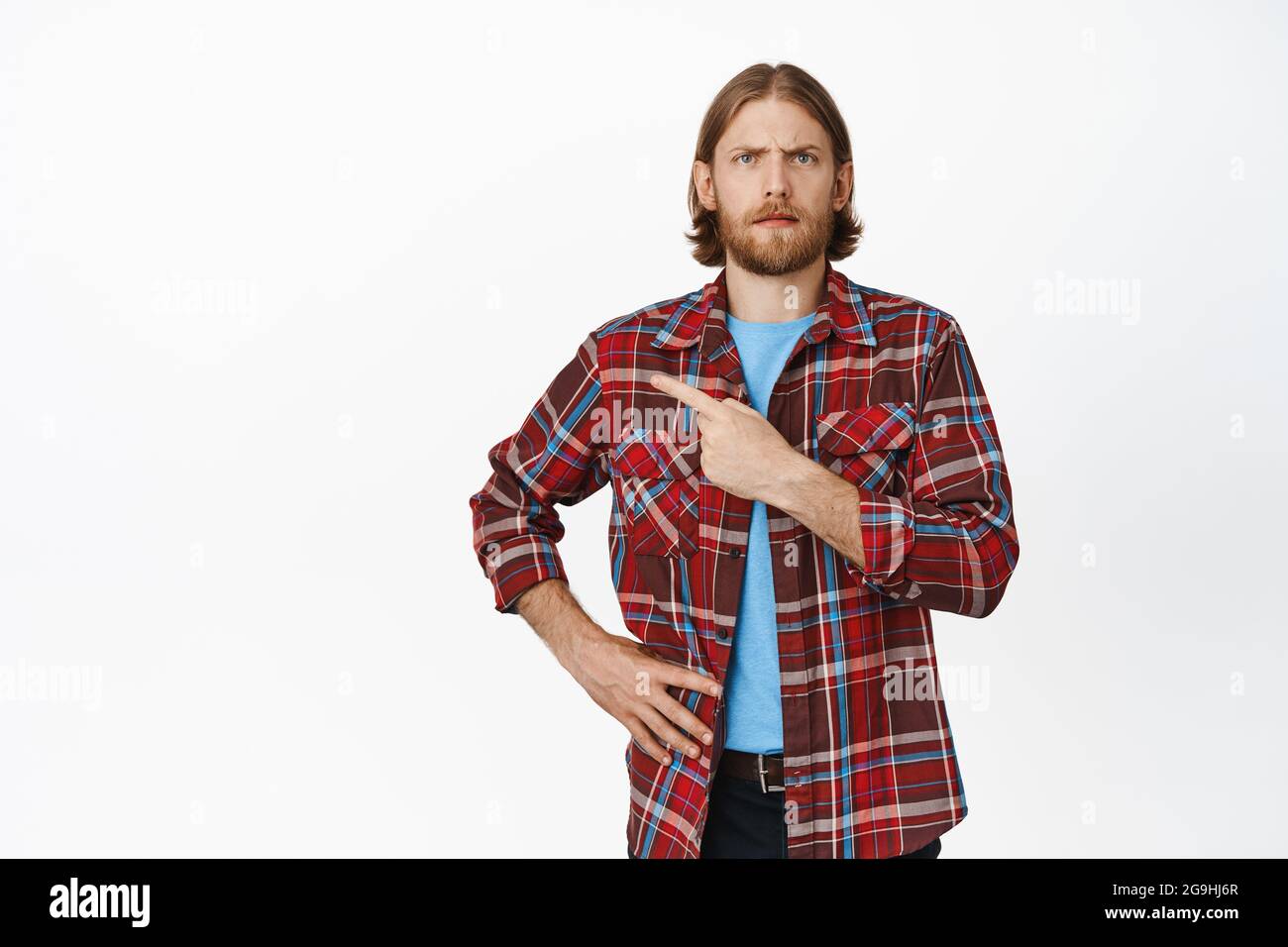 Confused and worried bearded adult man, furrow eyebrows, pointing ...