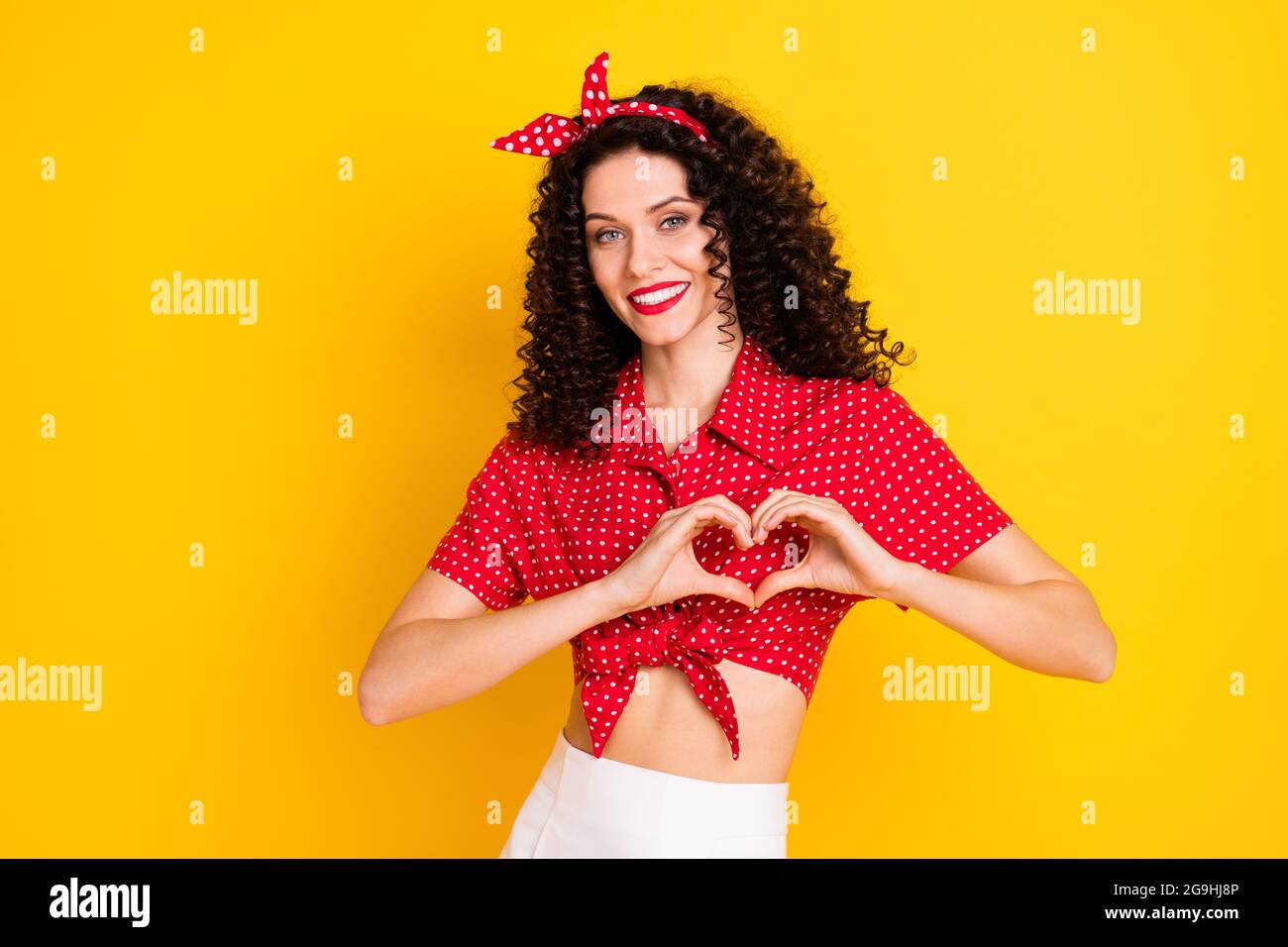 Photo of charming lovely young woman show heart shape fingers romantic ...