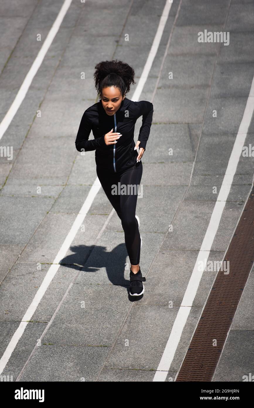 High angle view of african american runner training on track outdoors ...