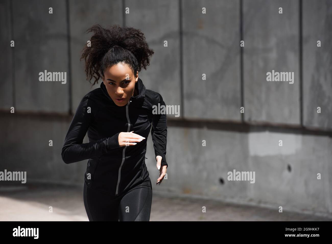 Pretty african american runner training outdoors Stock Photo - Alamy