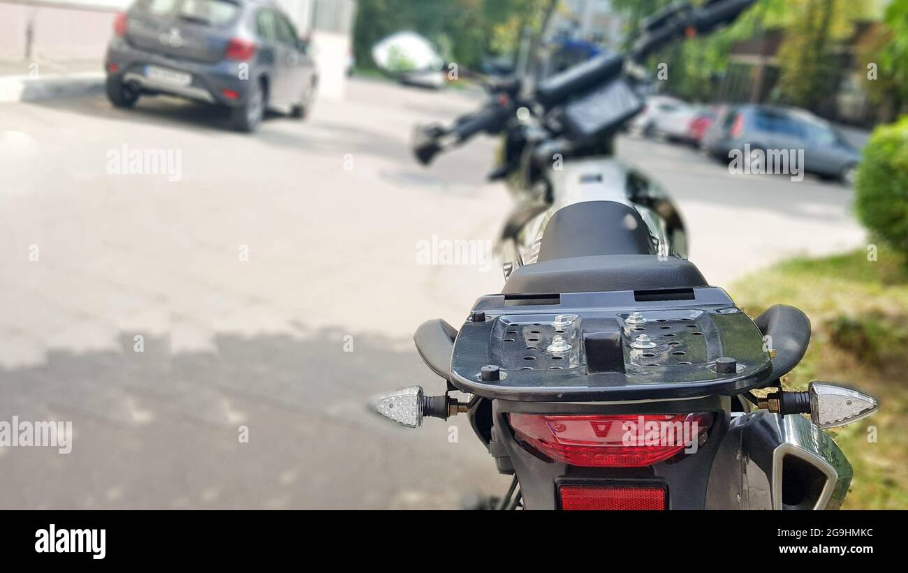 Black motorcycle parked. Back view. Soft focus Stock Photo - Alamy